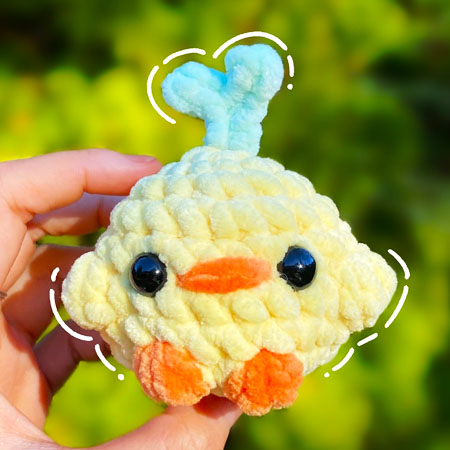 Crocheted Duck with a blue Sprout on its Head